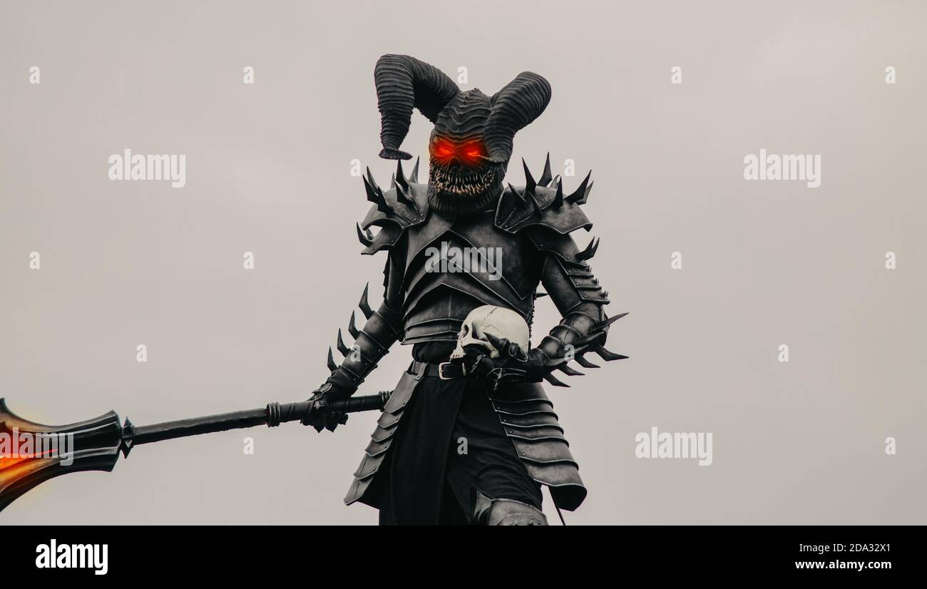 Mutant warrior stands with glowing eyes and holds mace and a human ...