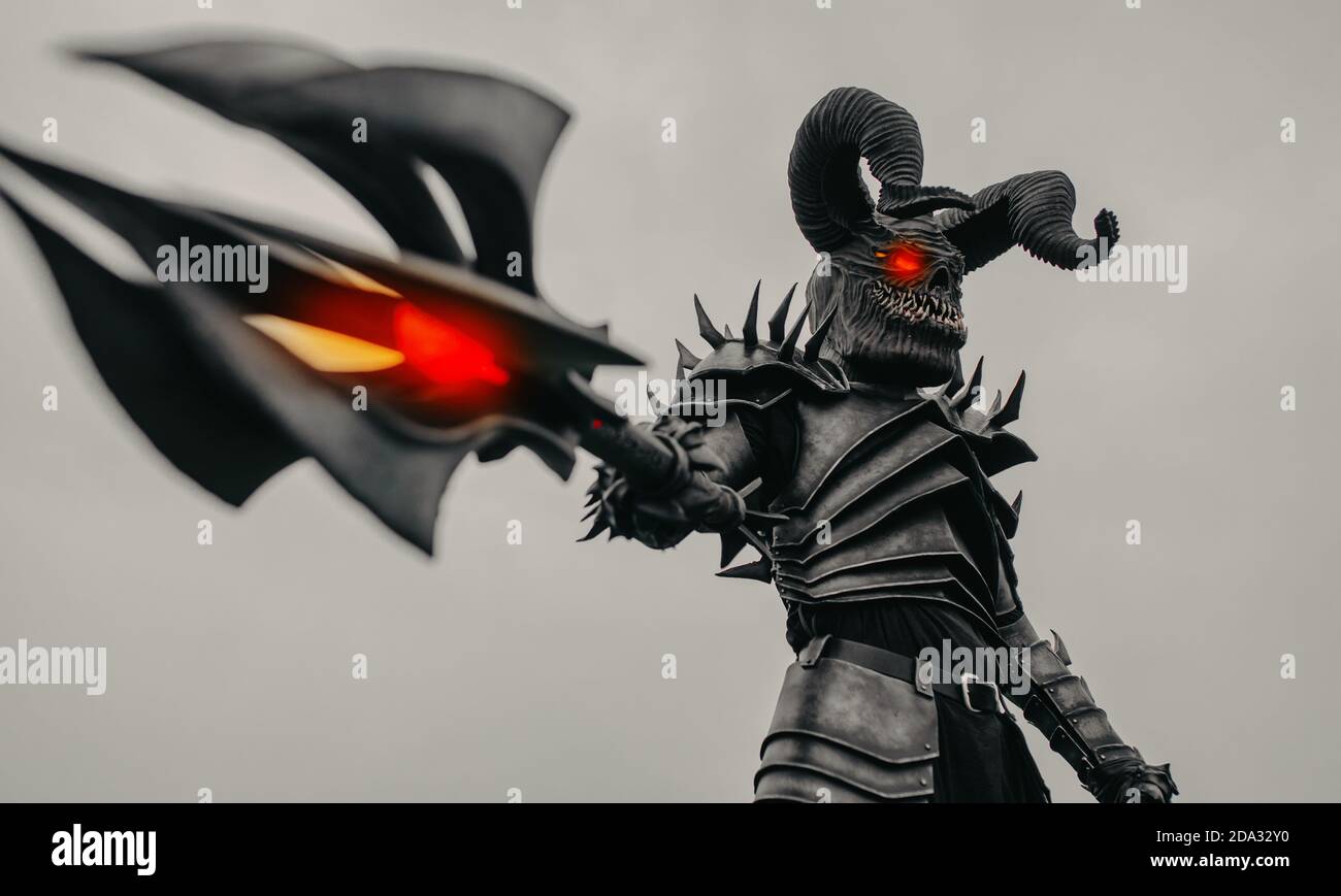 Mutant warrior stands with glowing eyes and holds mace in his hands ...