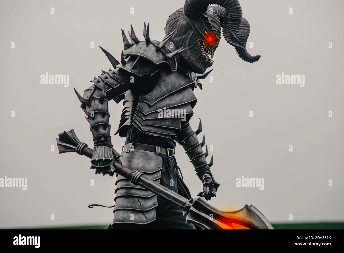 Mutant warrior stands with glowing eyes and holds mace in his hands ...