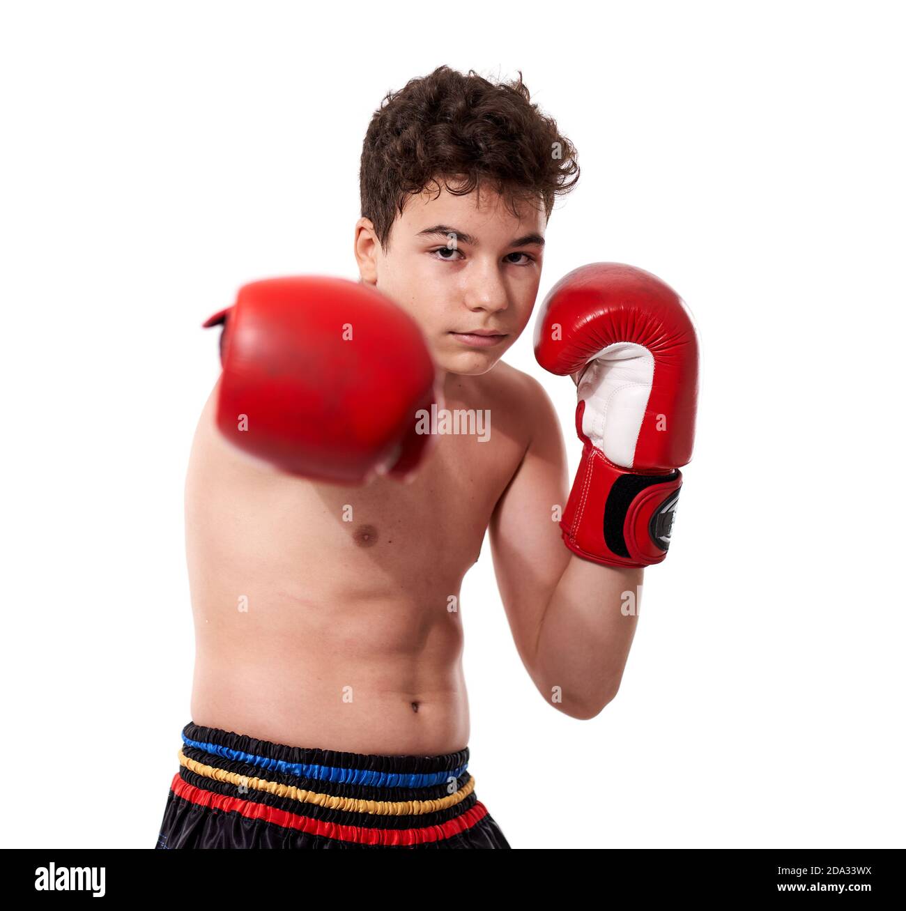 Young kickboxing fighter in red gloves with various strikes posing on ...
