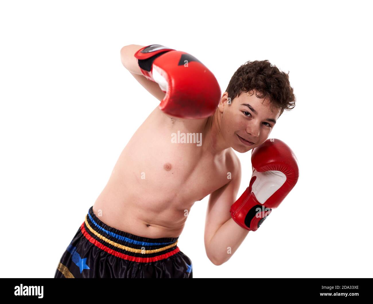 Young kickboxing fighter in red gloves with various strikes posing on ...