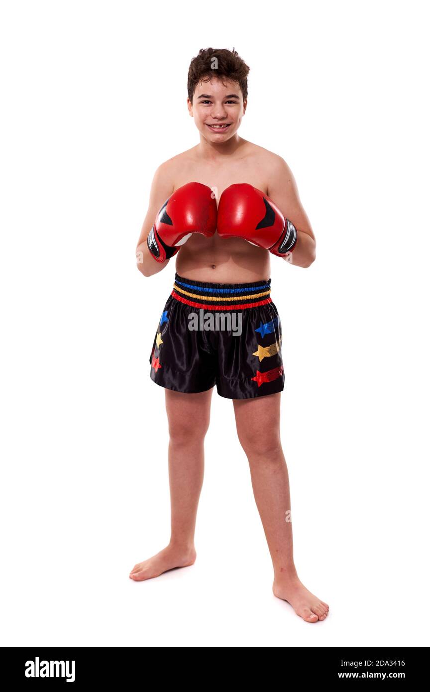 Young kickboxing fighter in red gloves with various strikes posing on ...