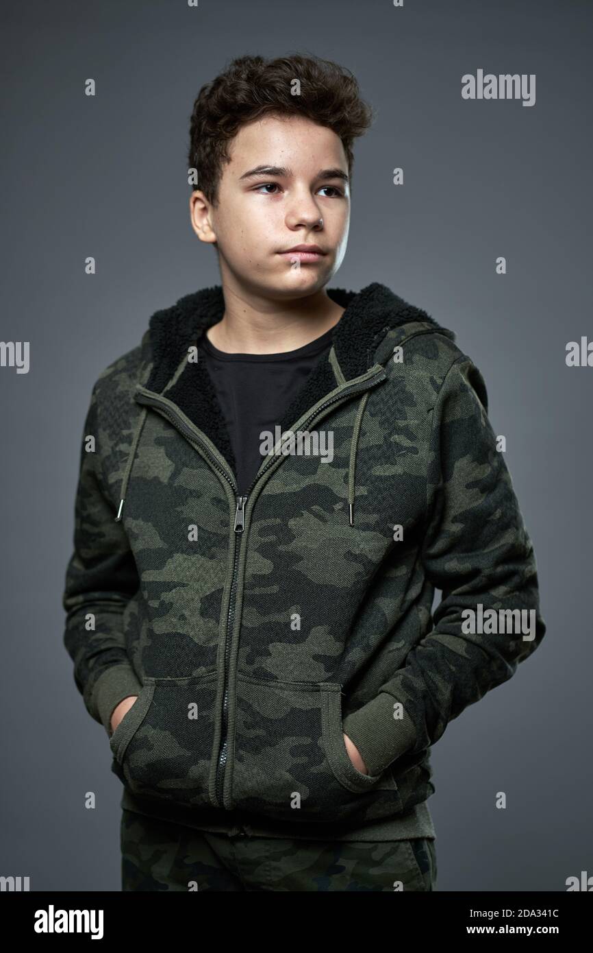 Closeup portrait of a trendy teenage boy with hands in pockets Stock ...