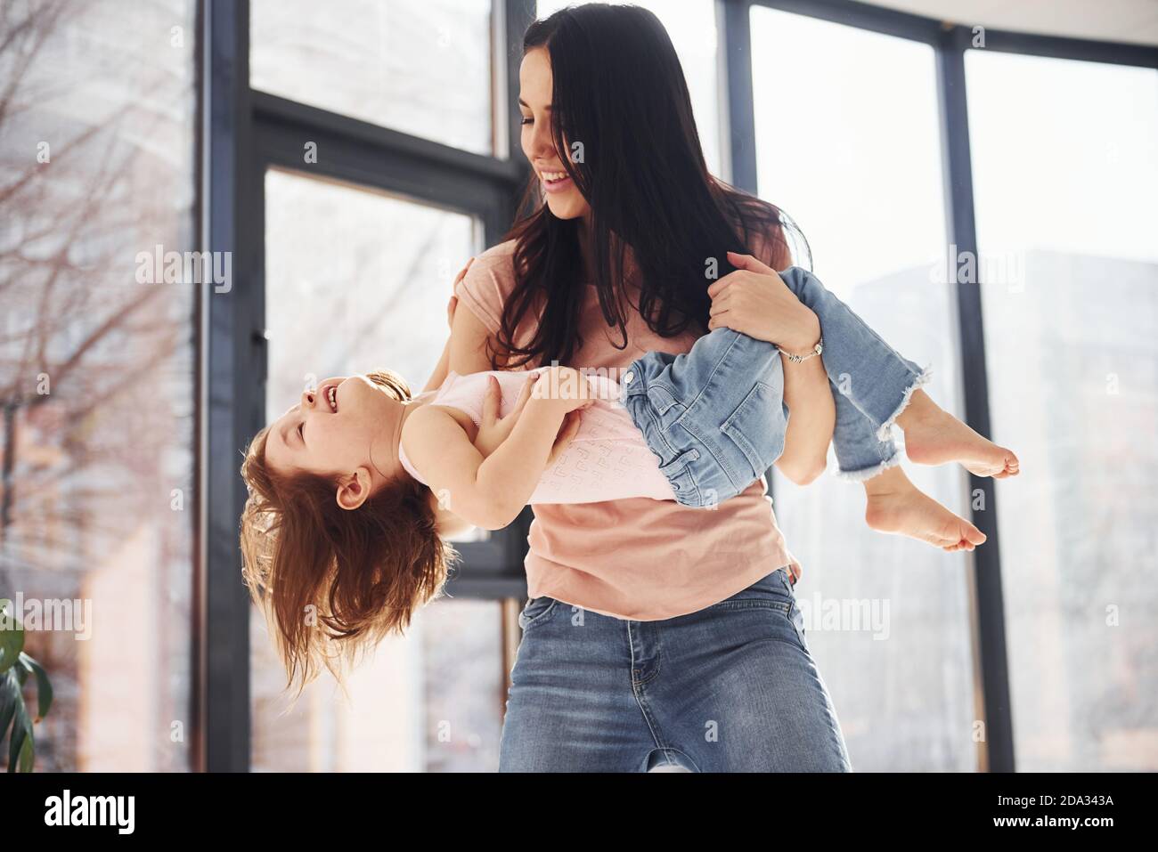 Young mother with her daughter spending weekend together on bed Stock ...