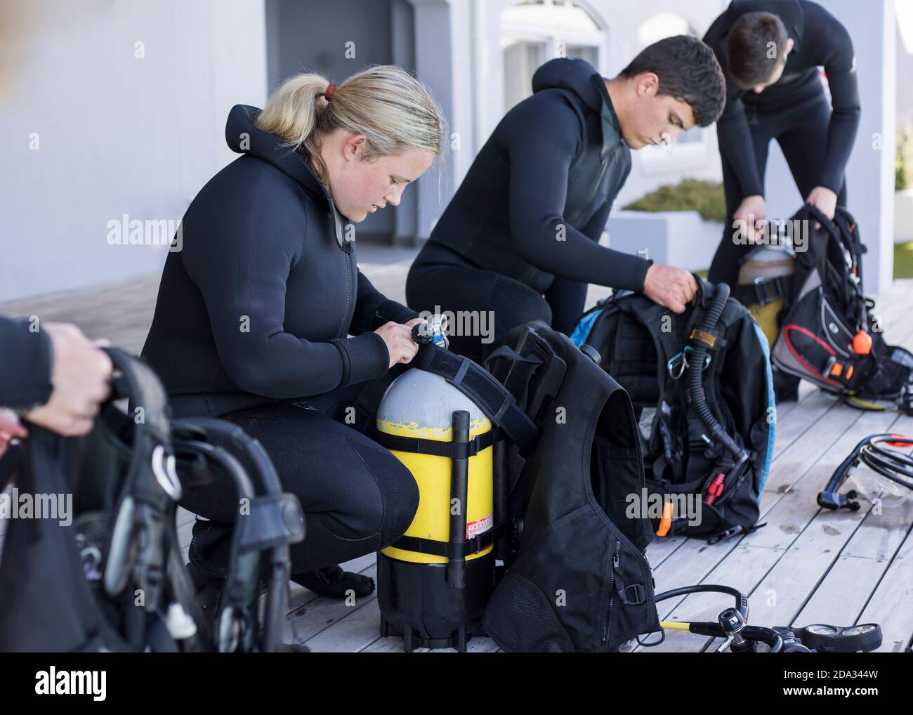 A group of scuba divers kitting up and checking their gear Stock Photo ...