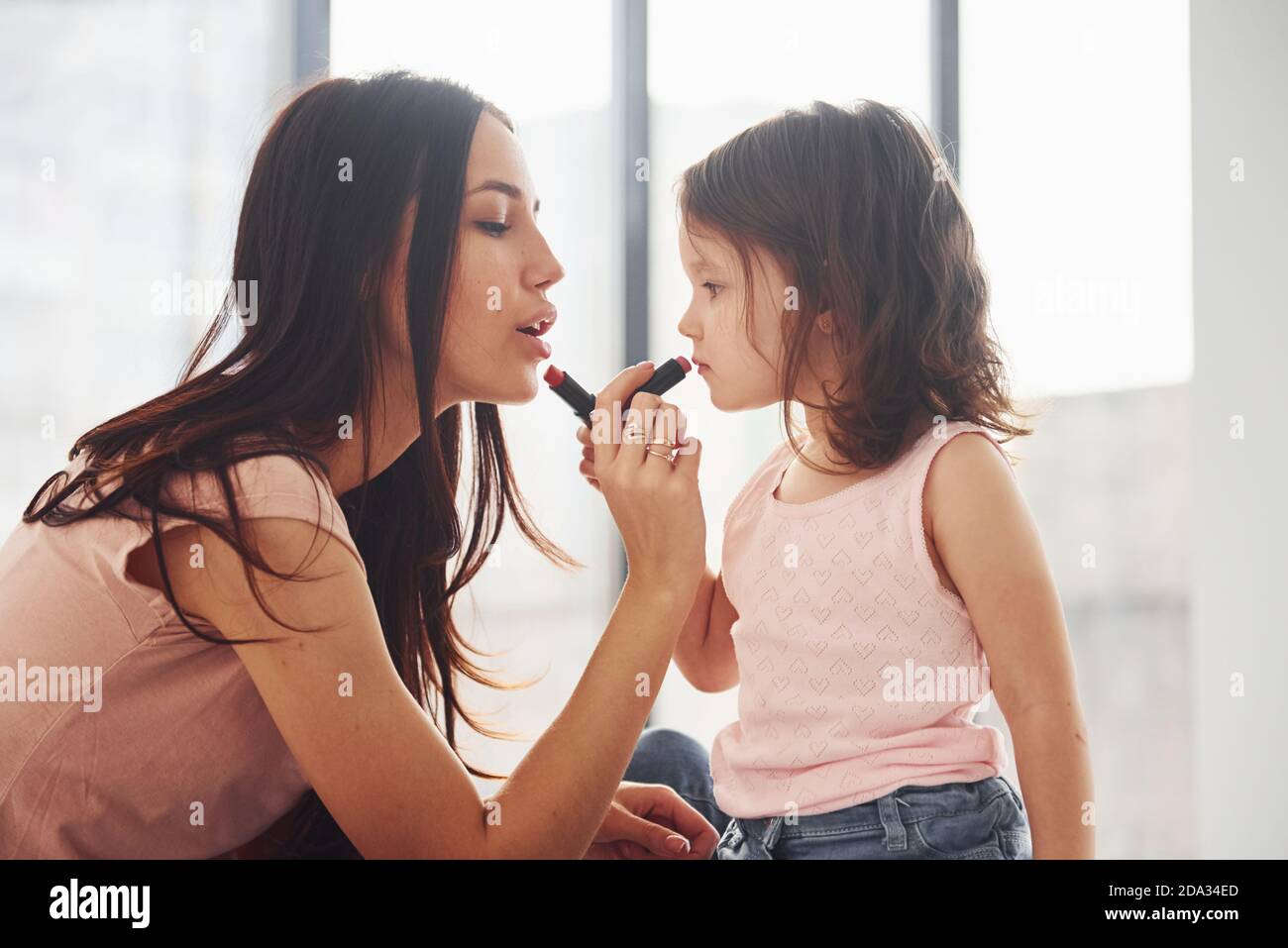 Learning how to make up. Young mother with her daughter spending ...
