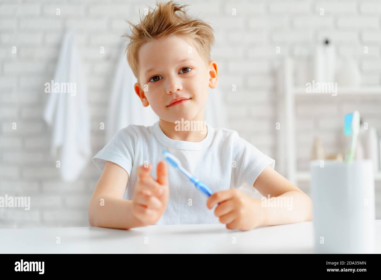 Little boy holding toothbrush in his hand Stock Photo - Alamy