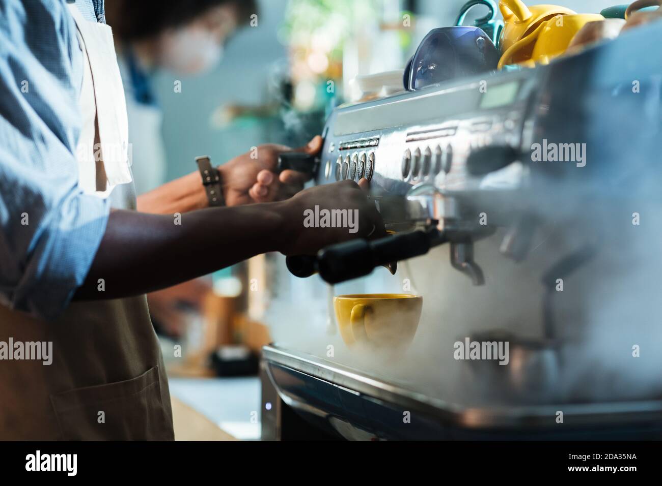 Barista make coffee with espresso machine in cafe and social distancing ...