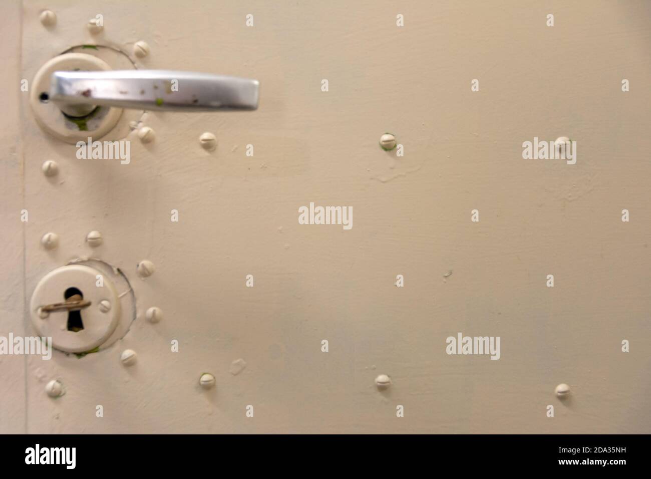 Old white metal door with lock, key and heck or door handle Stock Photo ...