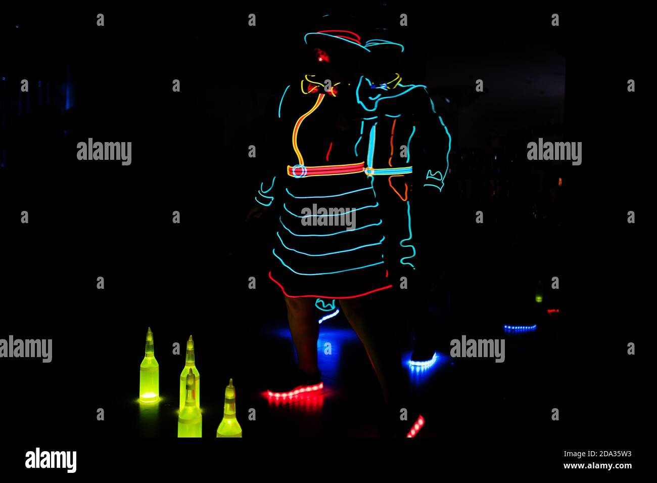 Professional barman and led light show. Silhouette of modern bartender ...