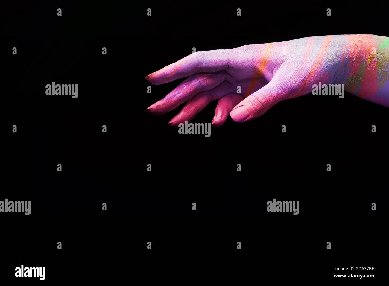 A beautiful female multicoloured hand wants to take something on a ...