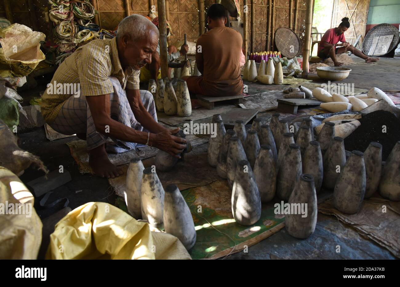 Guwahati, Assam, India. 8th Nov, 2020. Artist making traditional fire ...