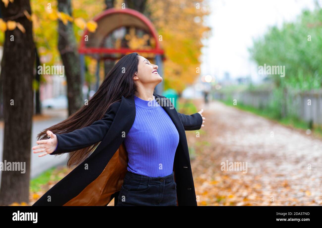 Portrait of a young woman in autumn. Scenery with warm light and ...