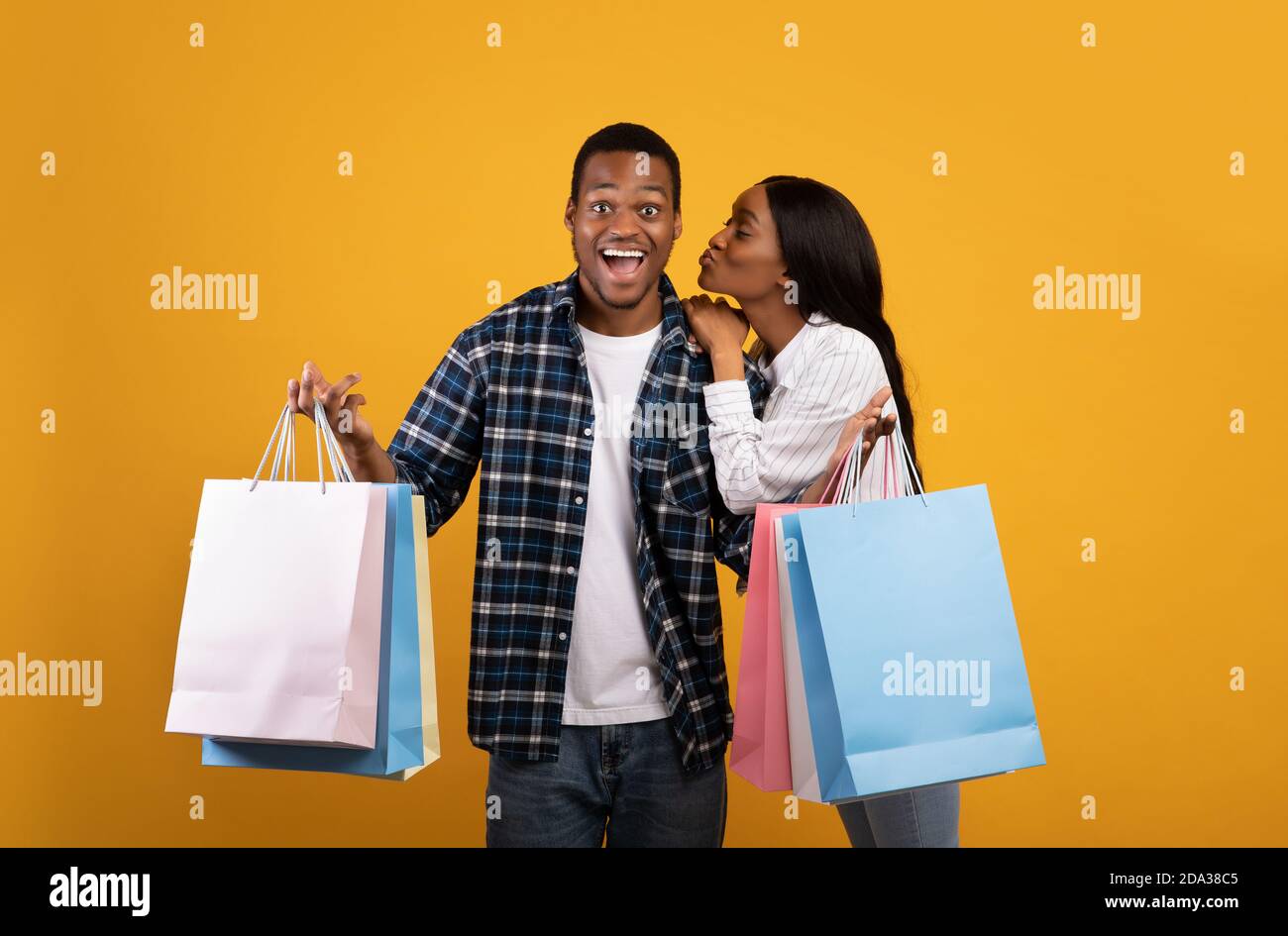 Surprised young african american guy with open mouth shows many color ...
