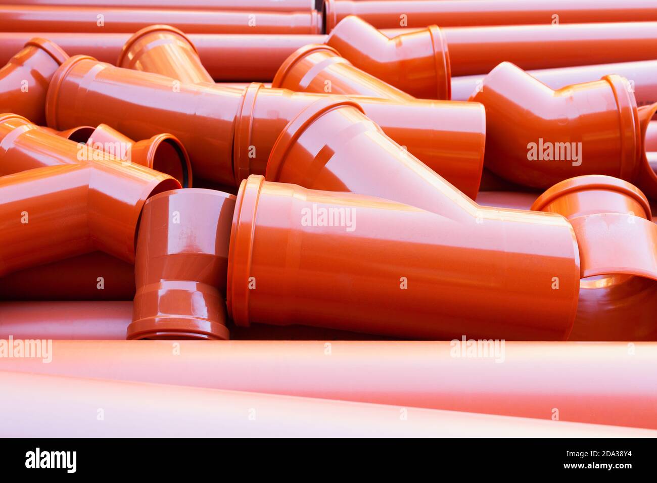Bunch of bright red pvc sewer pipes Stock Photo - Alamy