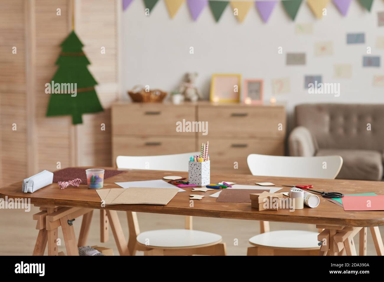 Background image of crafting table in decorated school classroom, copy ...