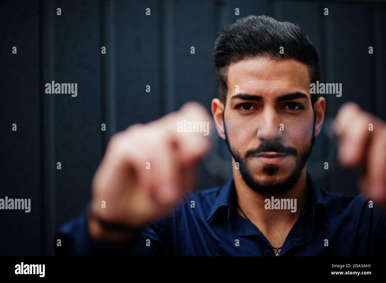 Middle eastern entrepreneur wear blue shirt show close up eyeglasses ...