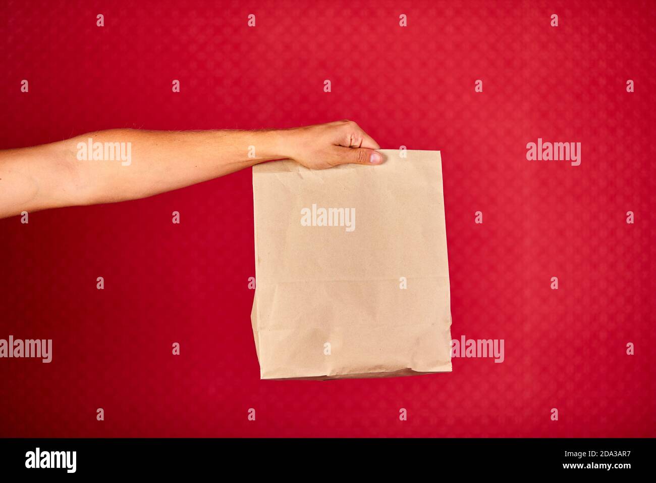 Closeup courier hand holding grocery paper bag, delivery service Stock ...