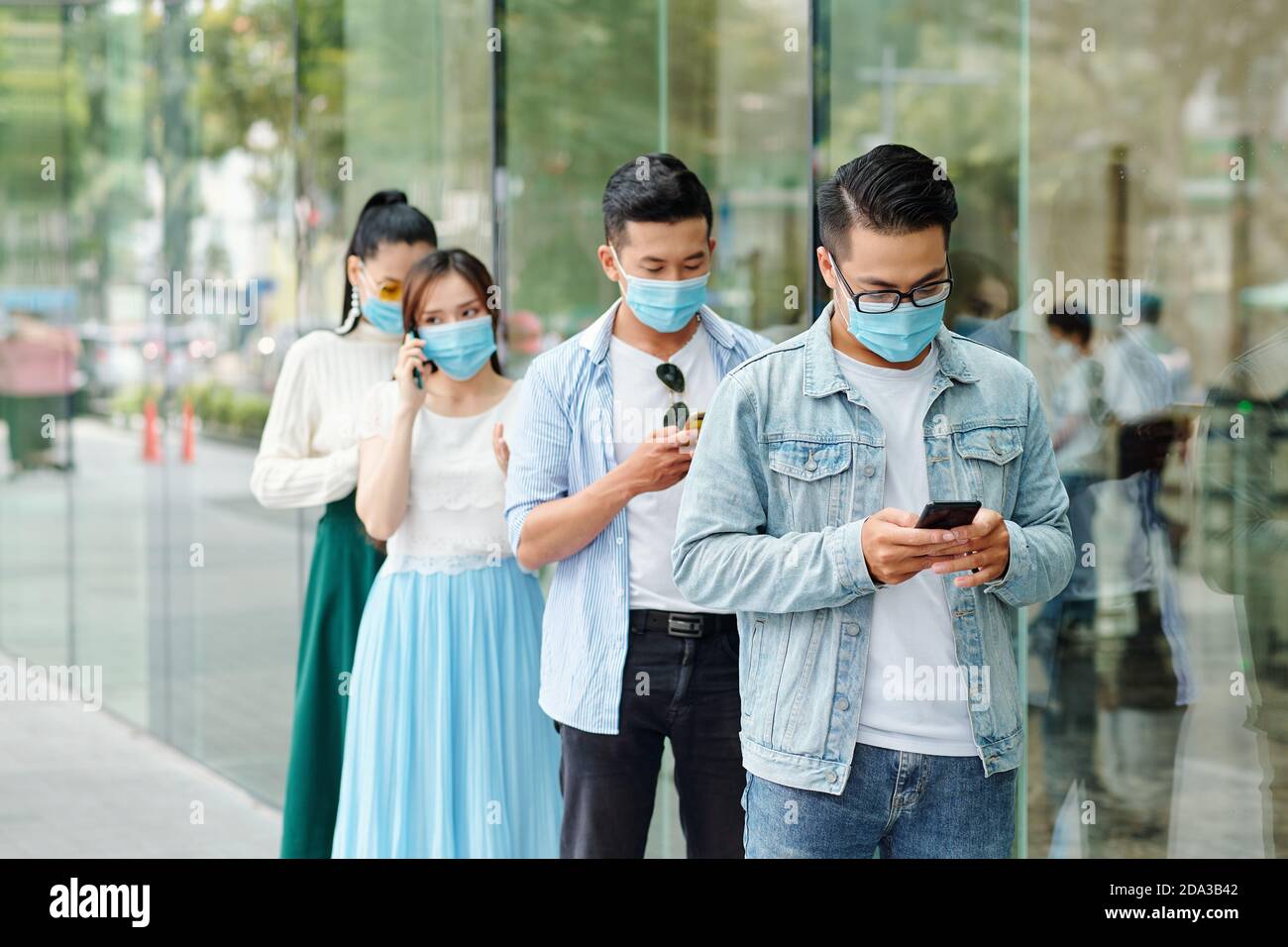 People standing in queue Stock Photo - Alamy
