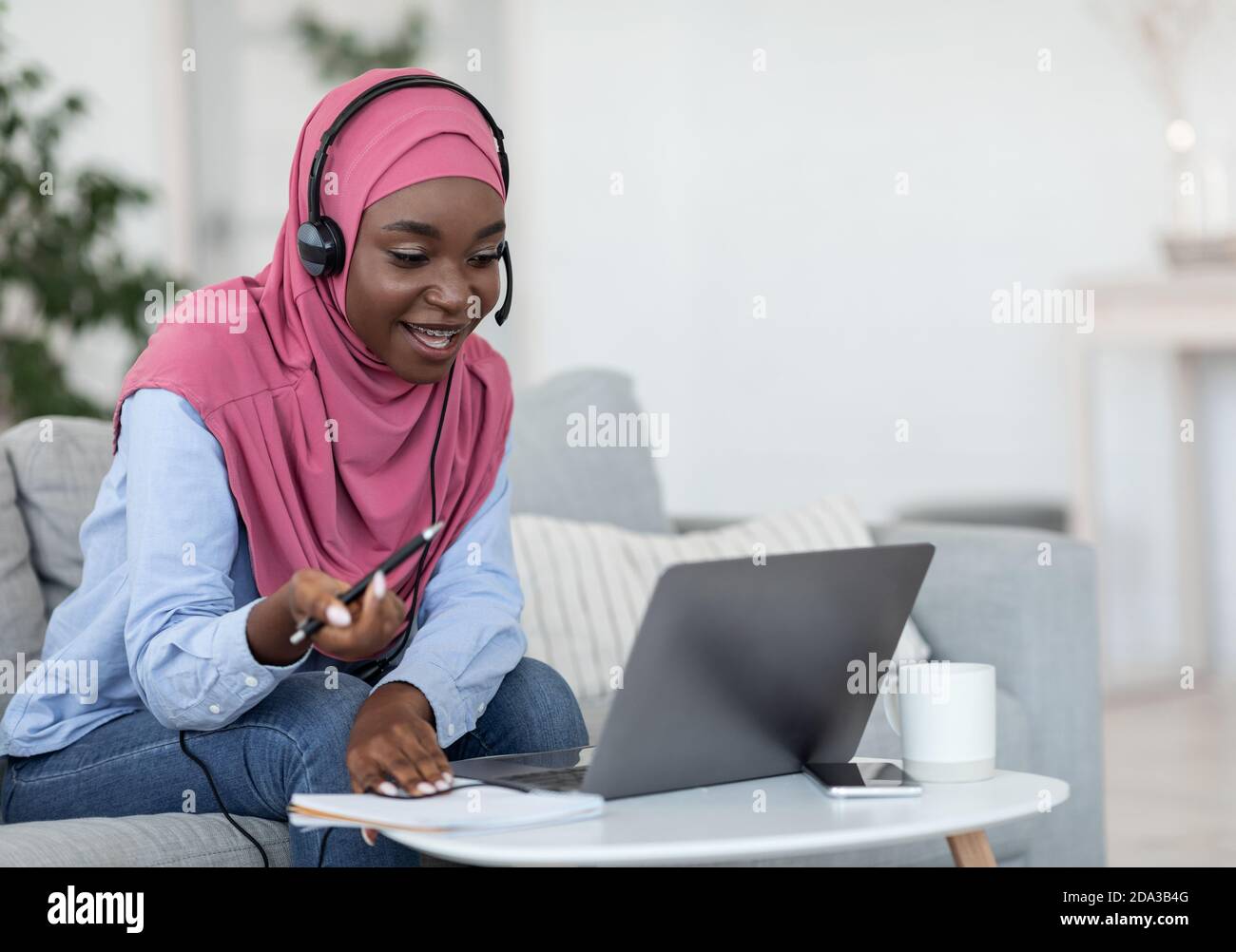 Online Tutoring. Friendly black muslim female tutor having video call ...