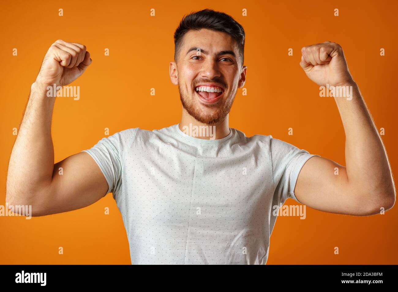 Portrait of excited, successful man raising hands up Stock Photo - Alamy