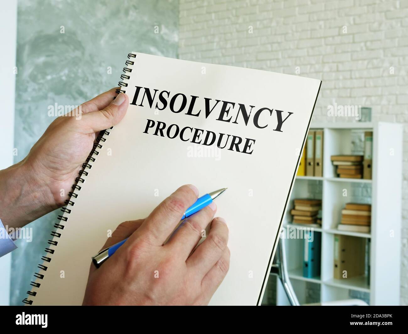 The man reads the insolvency procedure in the book Stock Photo - Alamy