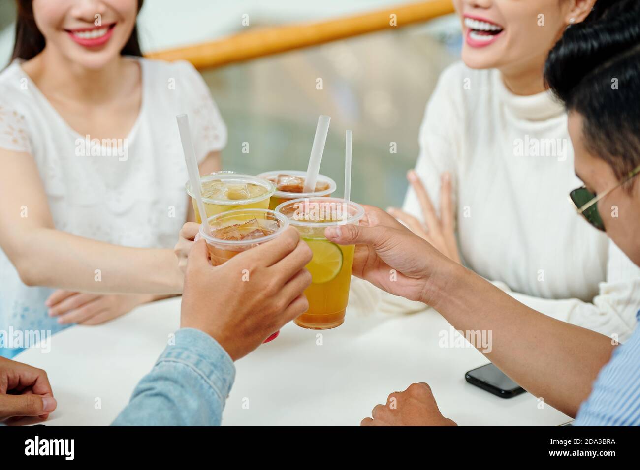 Friends drinking in cafe Stock Photo - Alamy