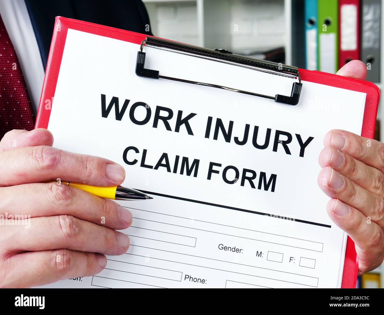 Work injury claim form is in the man hands Stock Photo - Alamy