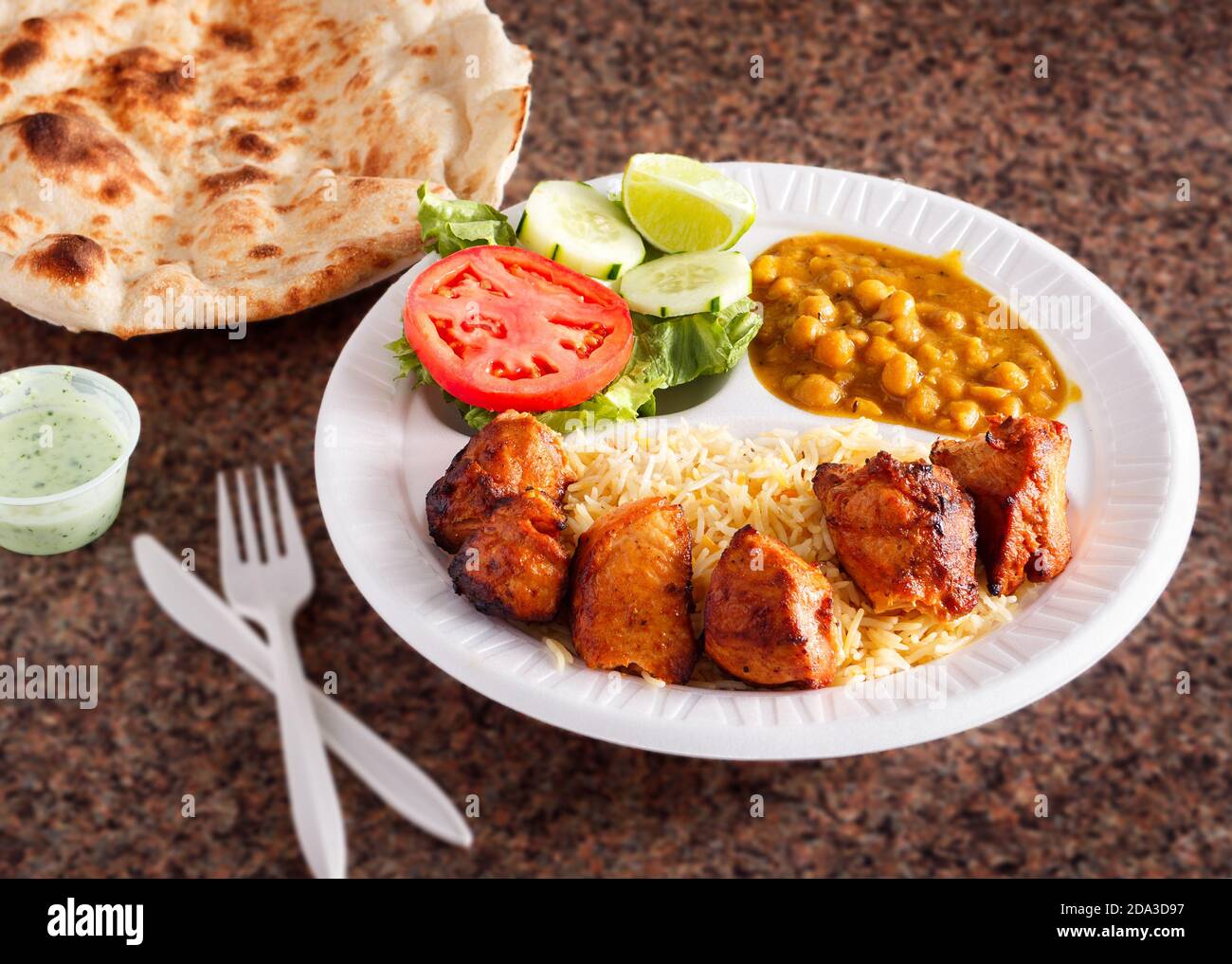 Mideastern chicken kebab platter with rice, chickpeas, salad and naan ...