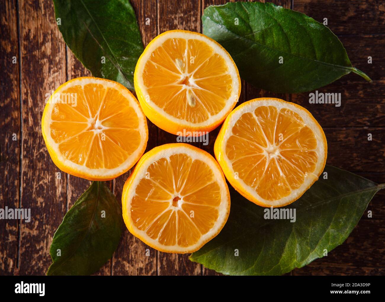 Overhead view of Meyer lemon halves on a rustic wooden surface Stock Photo - Alamy