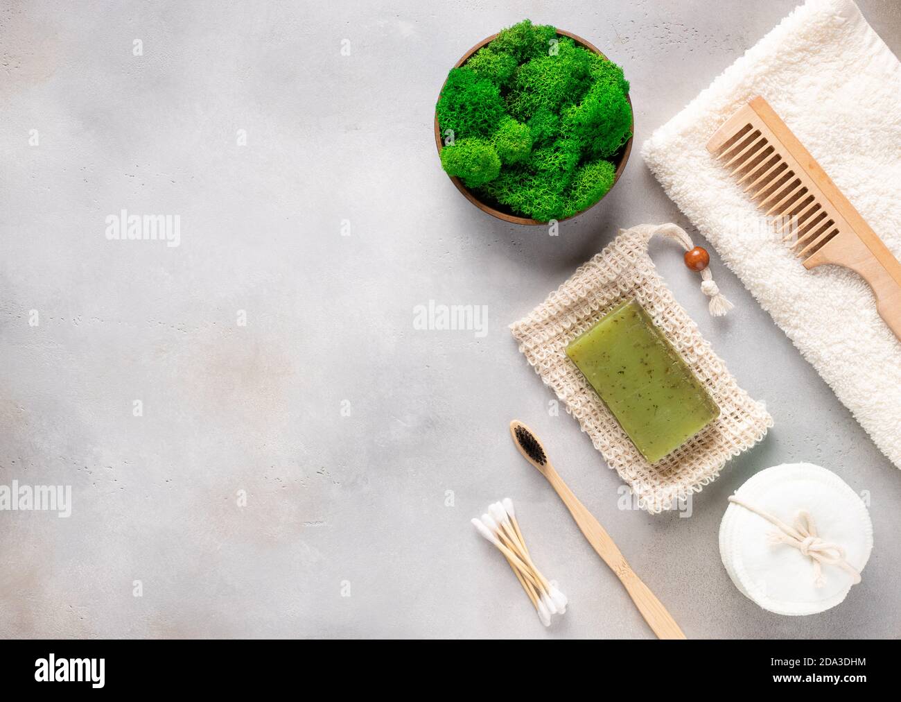 Eco-friendly bath accessories and stabilized moss in pot on gray ...