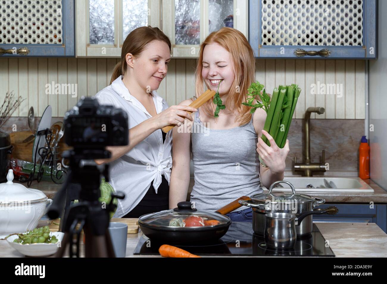 mom and daughter are recording a funny cooking show. food vlogging ...