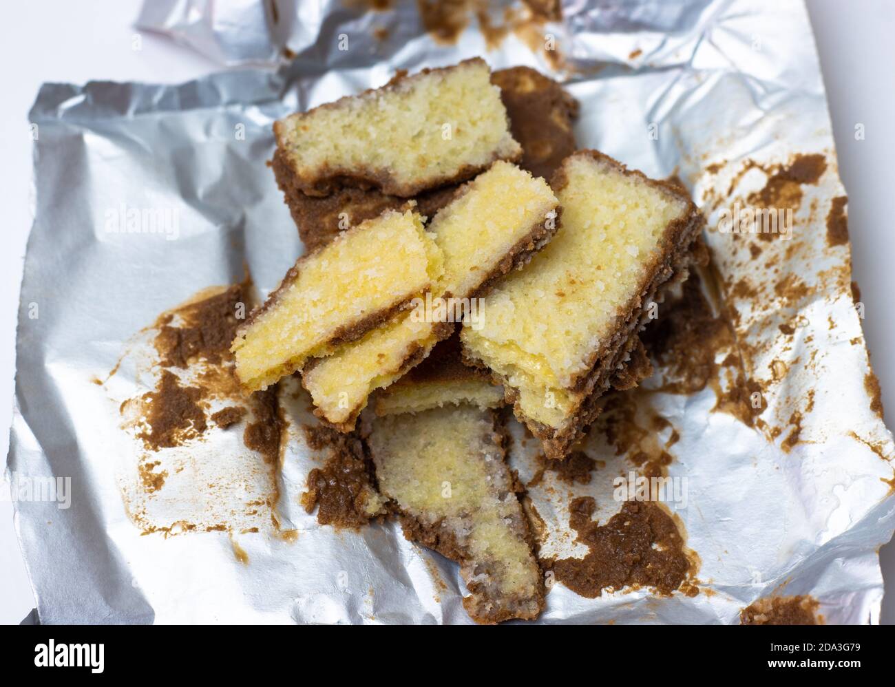 Broken cake biscuit on an open packet isolated on white background ...