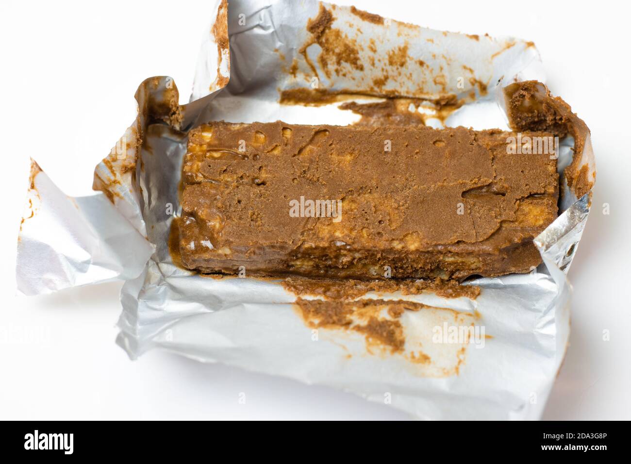 Delicious chocolate bar on an open packet isolated on white background ...