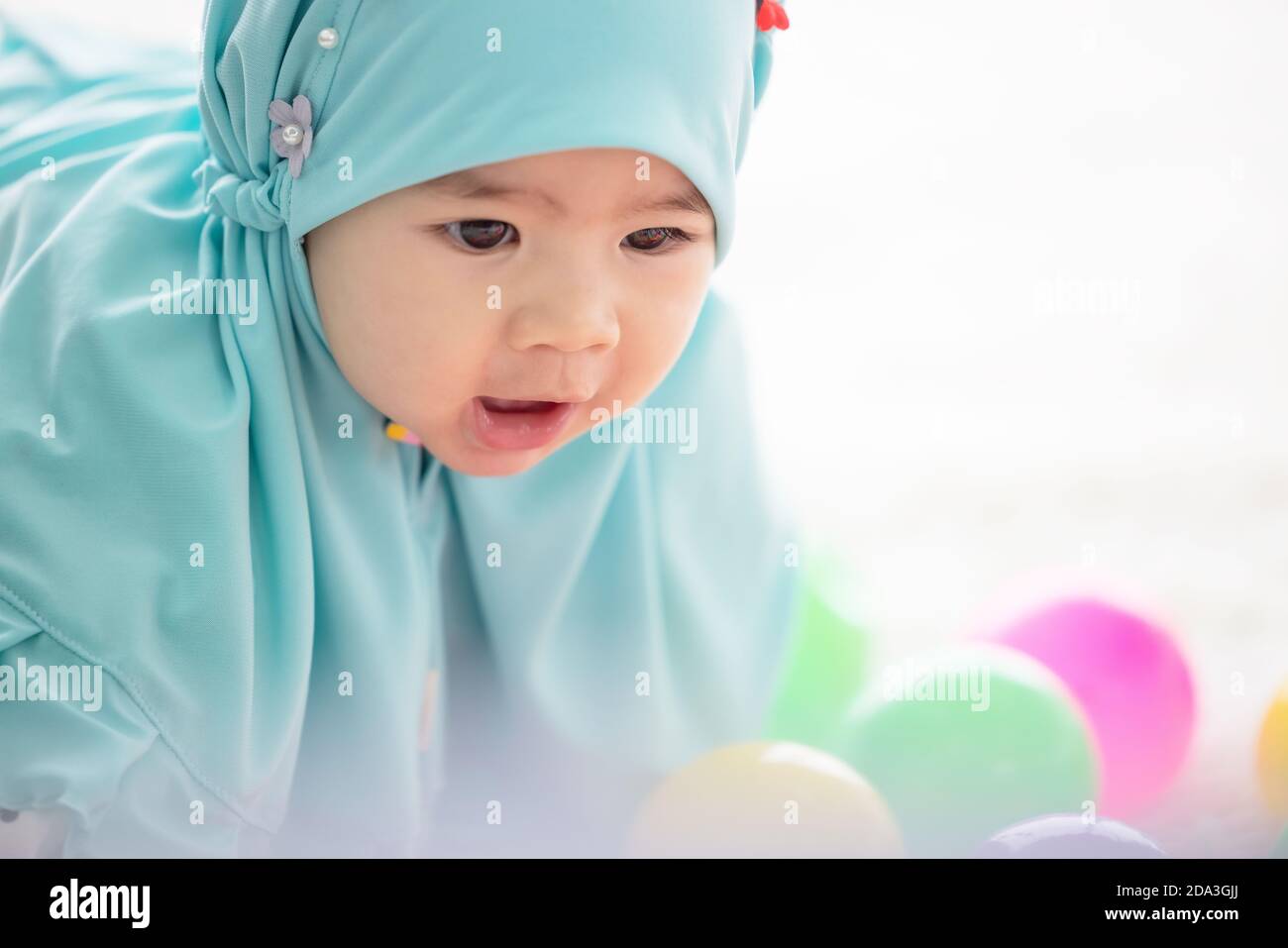 Muslim Baby plays with colorful toys in the living room Stock Photo - Alamy