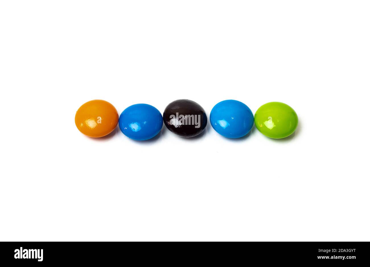 Straight line of colorful chocolate candy isolated on white background ...