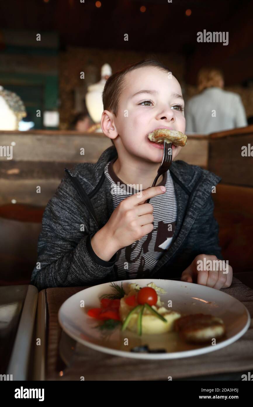 Boy eats chicken cutlet hi-res stock photography and images - Alamy