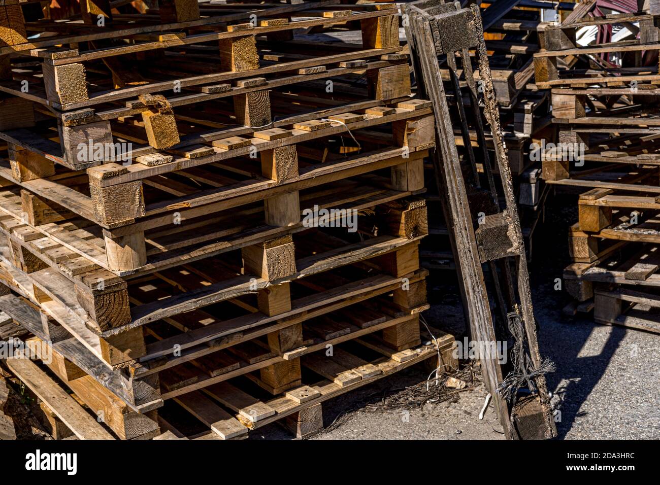 Many pallets stacked in stock, warehouse pallets. Old wood material ...