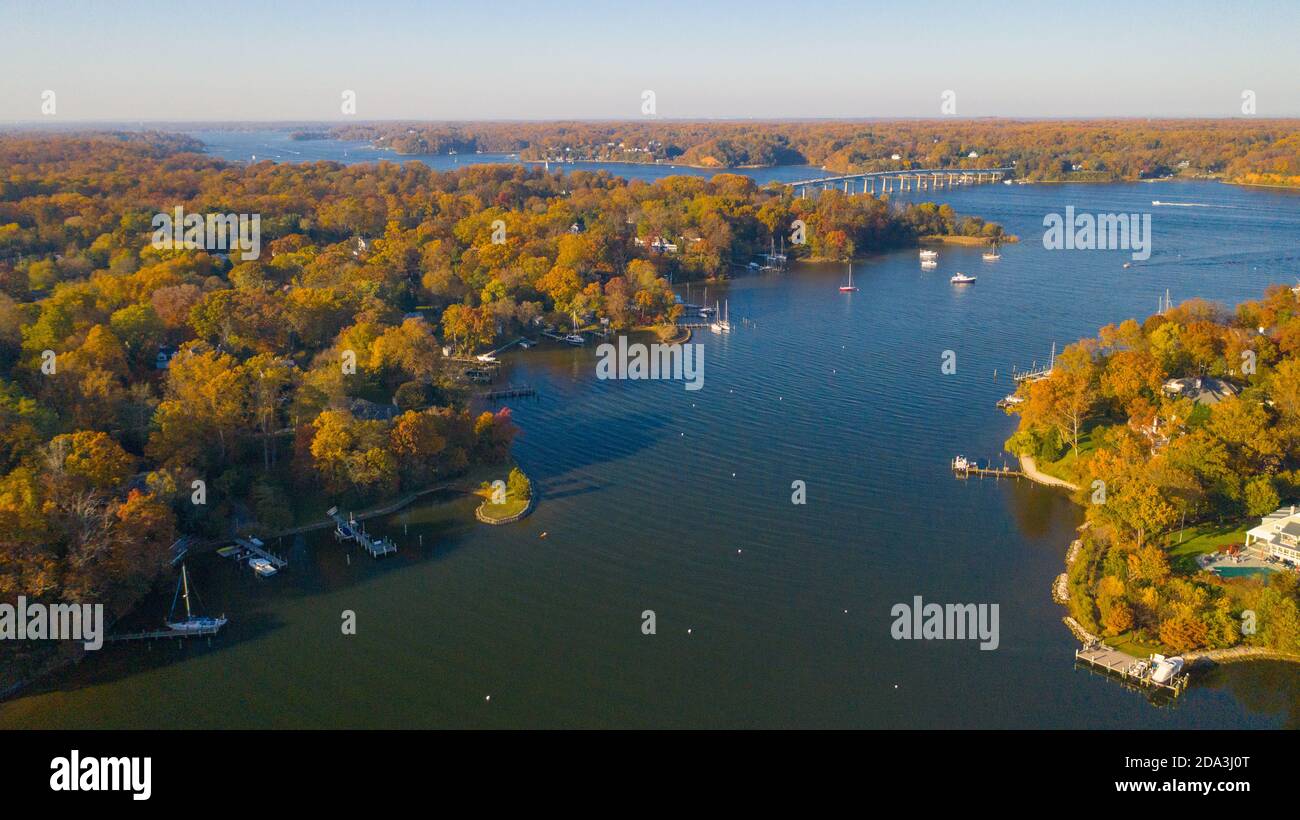 Aerial view of colorful sailboat moorings, docks, and bright golden ...