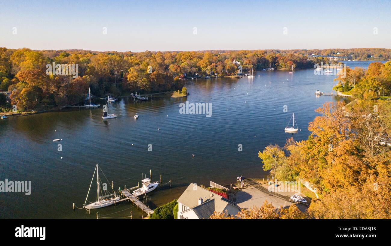 Aerial view of colorful sailboat moorings, docks, and bright golden ...