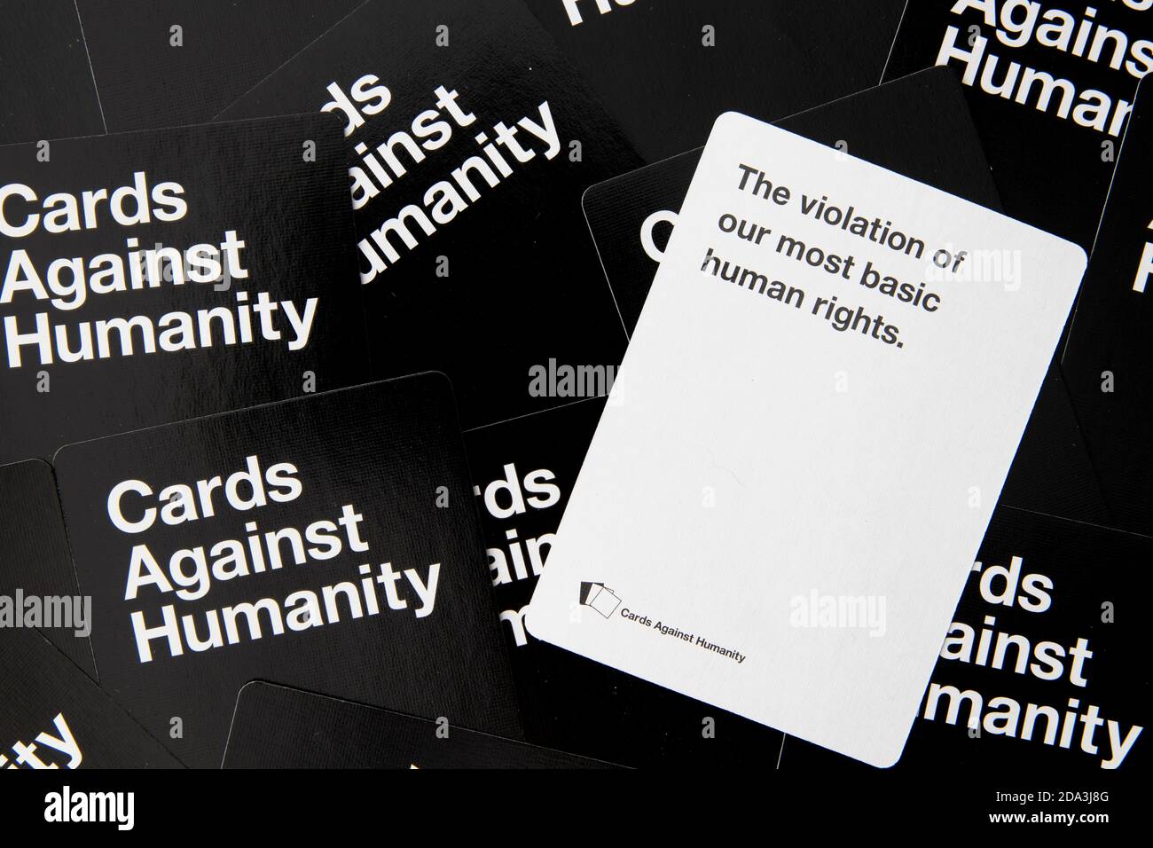 Adult party game cards against humanity scattered white and black cards ...
