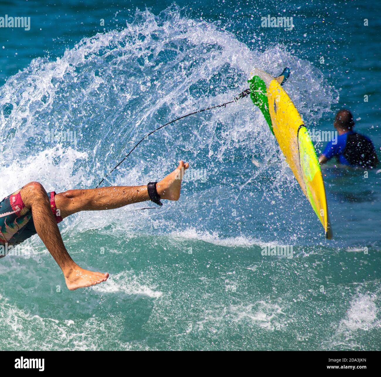Surfer falling off his board Stock Photo - Alamy