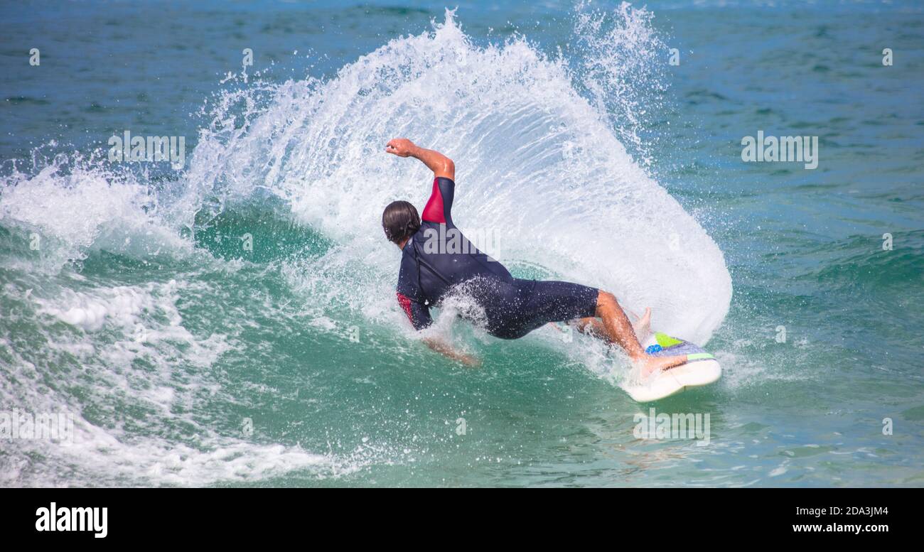 Surfer falling off his board Stock Photo - Alamy