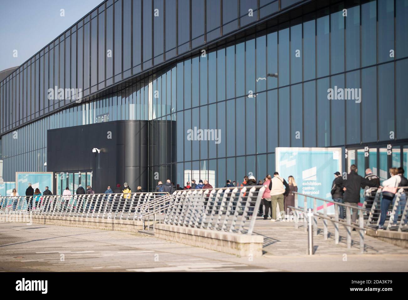 06/11/2020. Liverpool, UK. People queue along the side of the ...