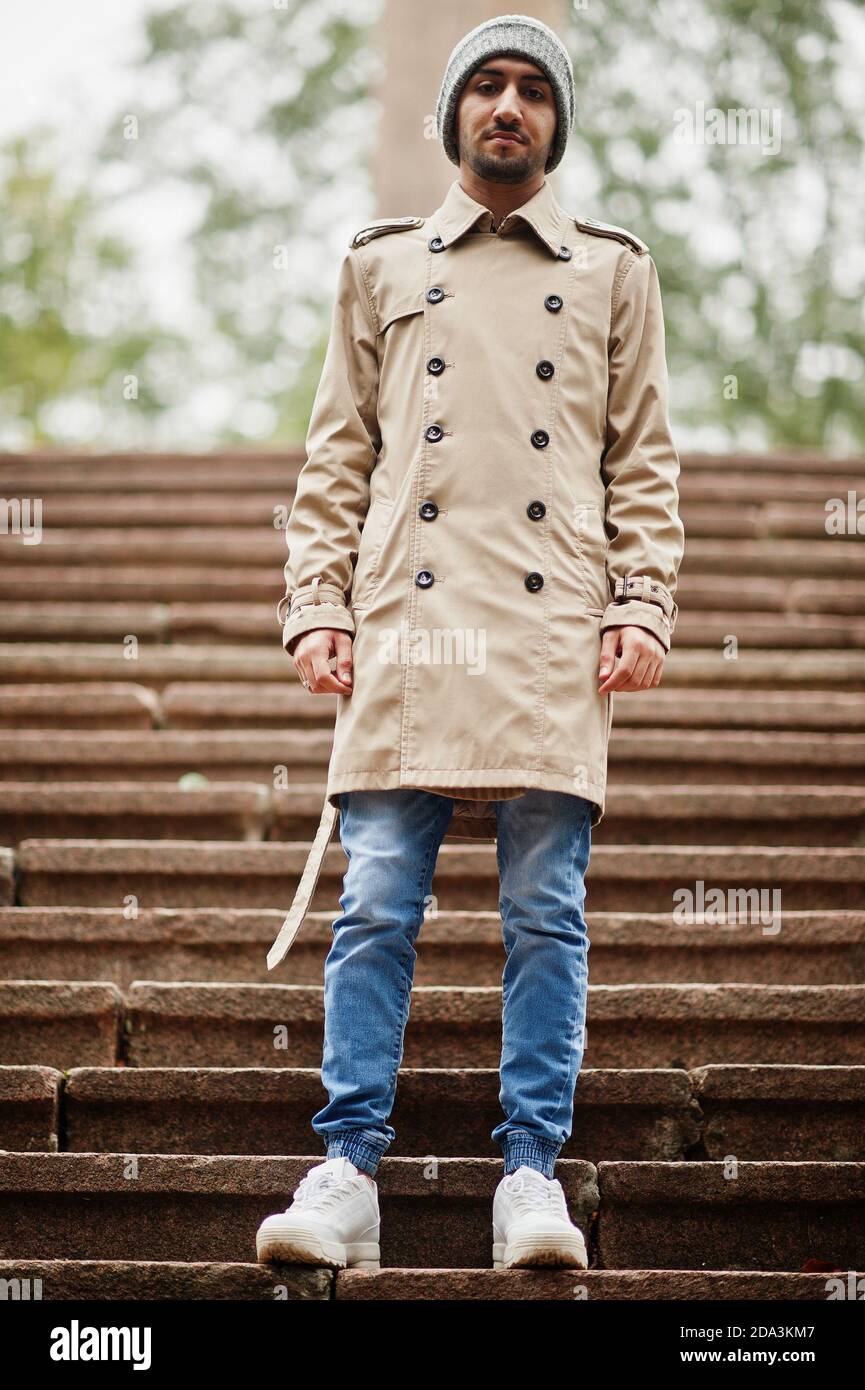 Stylish kuwaiti man at trench coat and hat Stock Photo - Alamy
