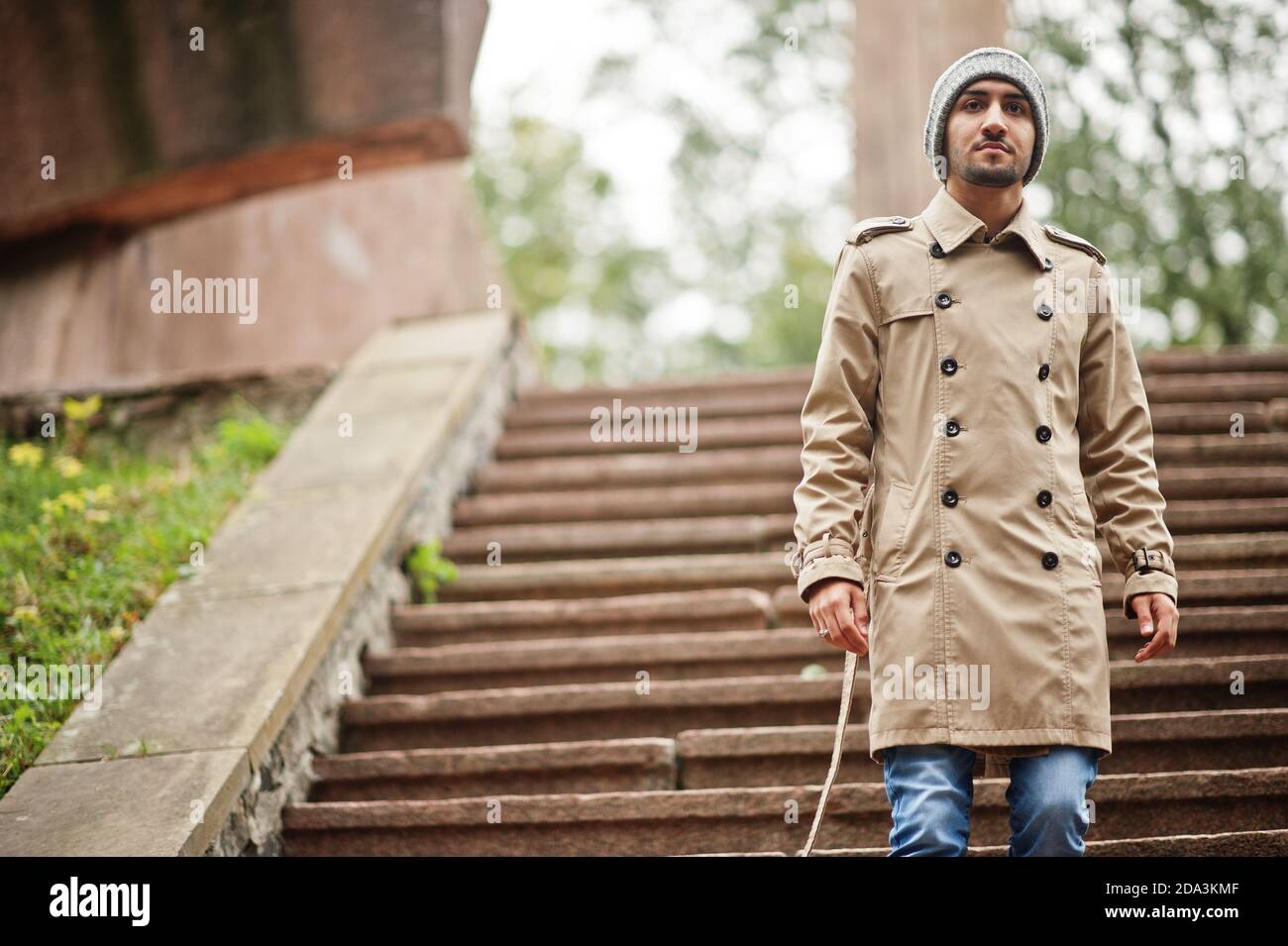 Stylish kuwaiti man at trench coat and hat Stock Photo - Alamy