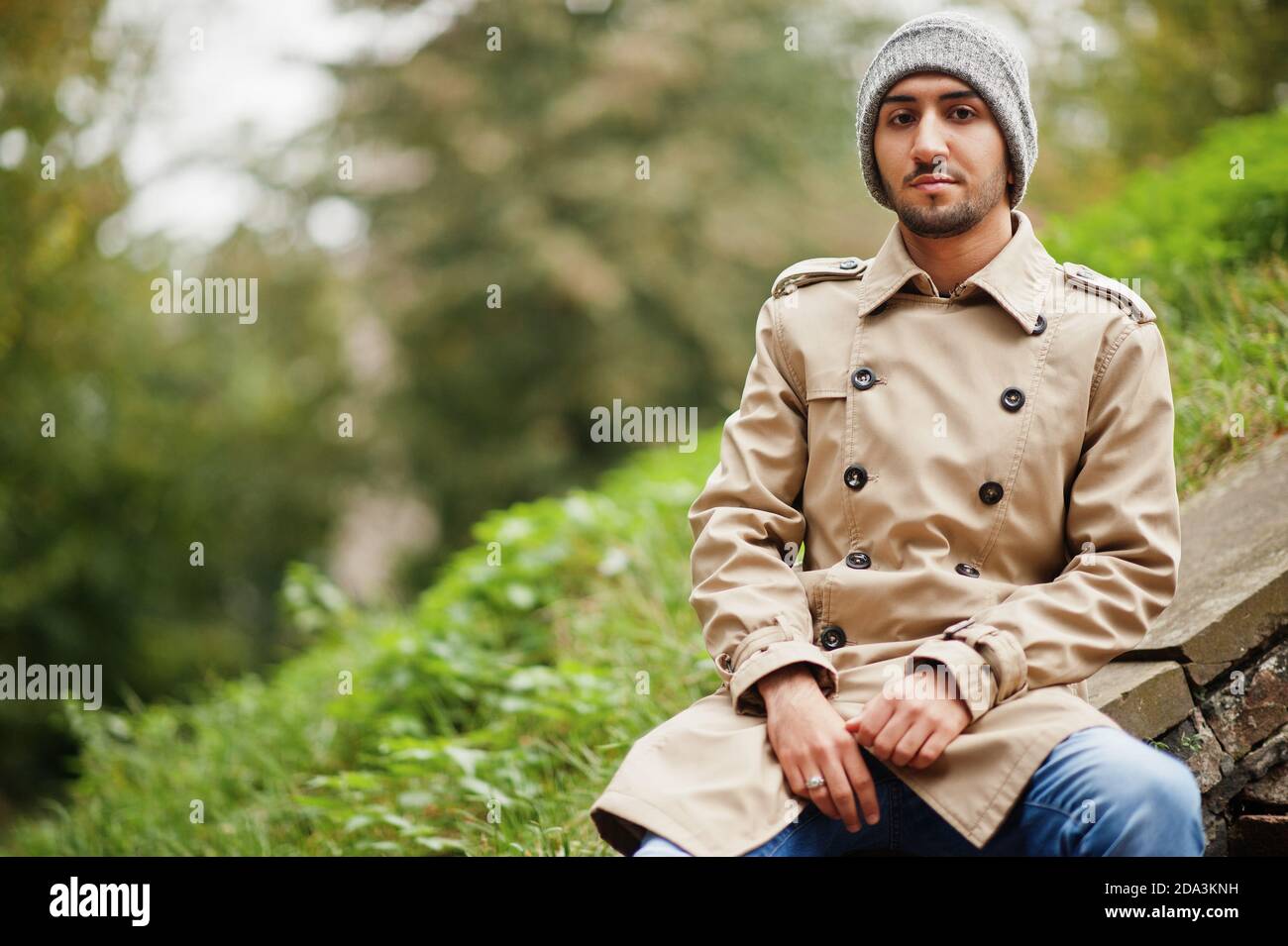 Stylish kuwaiti man at trench coat and hat Stock Photo - Alamy