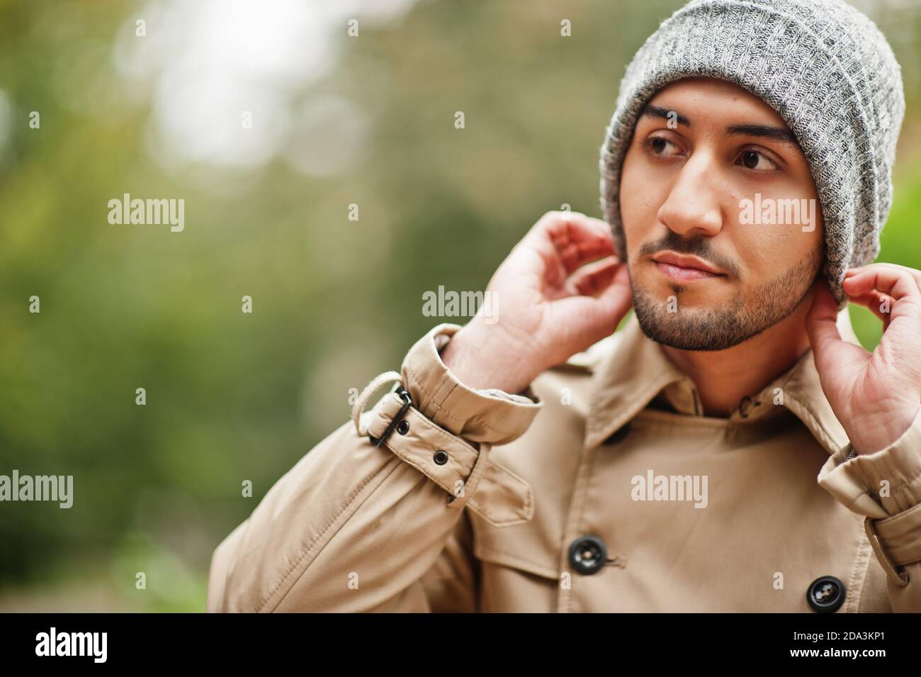 Stylish kuwaiti man at trench coat and hat Stock Photo - Alamy