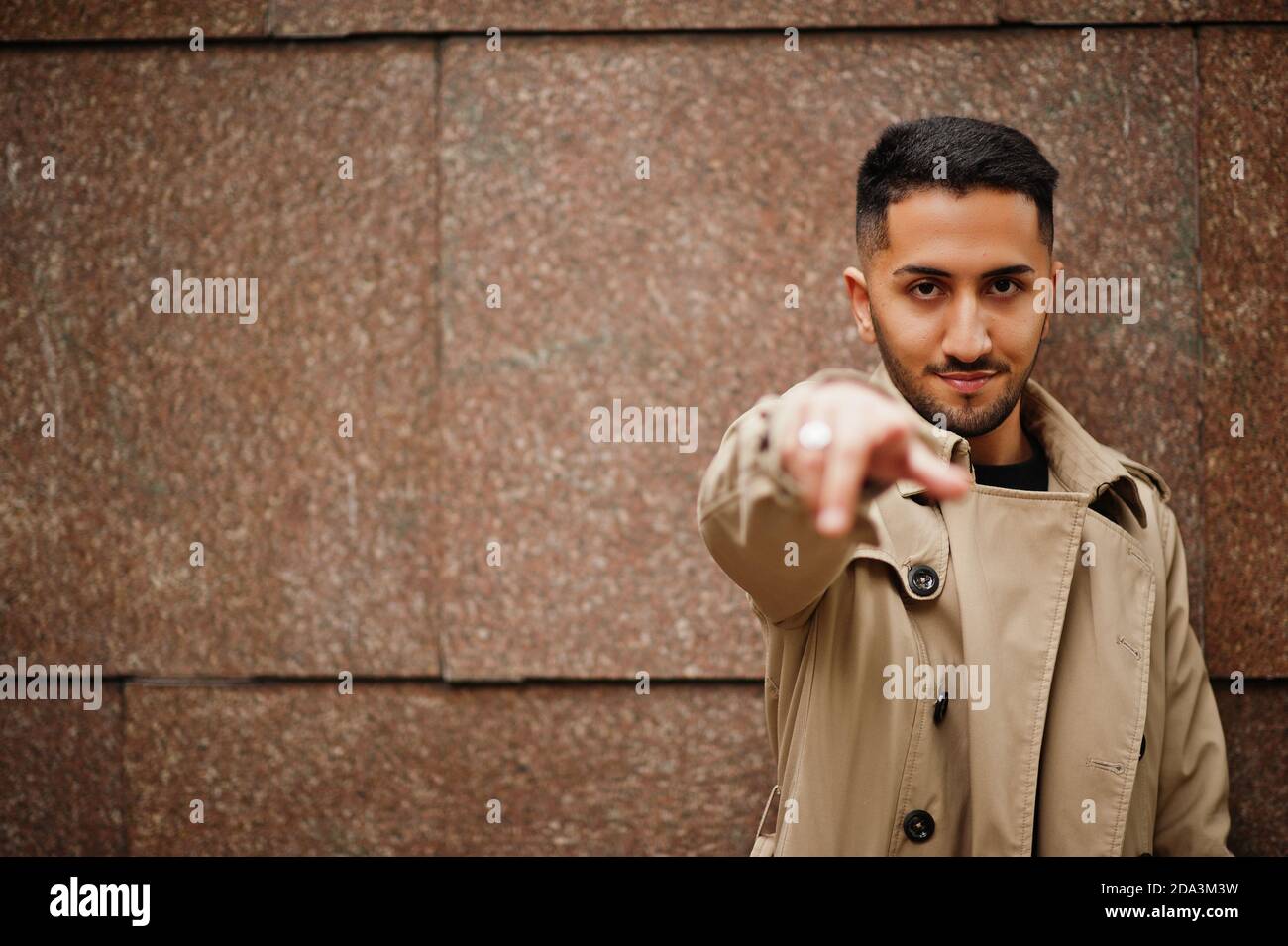Stylish kuwaiti man at trench coat show finger to camera Stock Photo ...