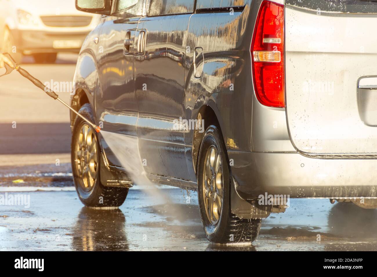 Manual washing of a minibus car with a high-power jet spray gun Stock ...